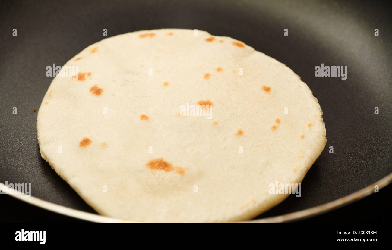 Making sourdough leavened pita-like flatbread on dry frying pan Stock ...