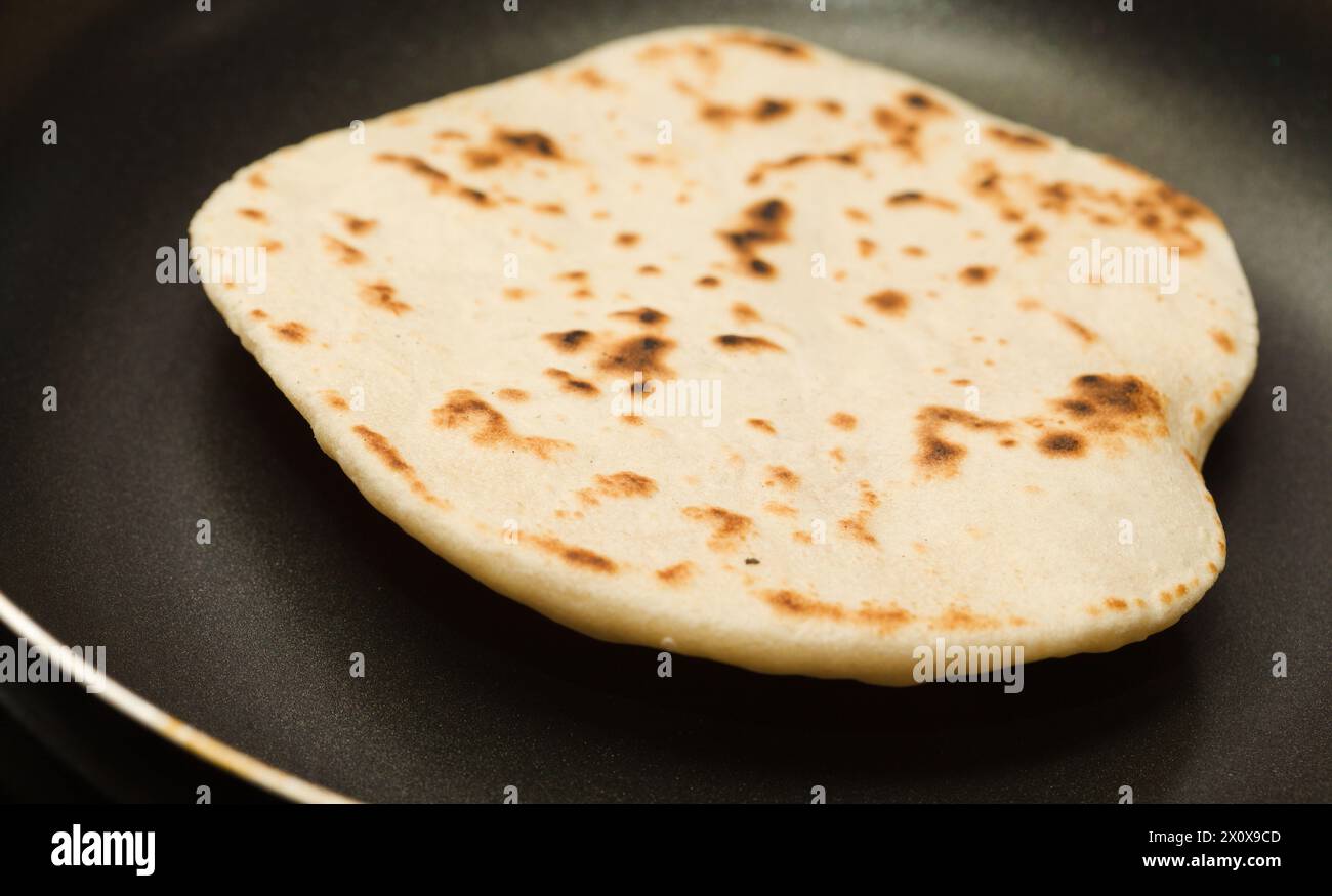 Making sourdough leavened pita-like flatbread on dry frying pan Stock ...