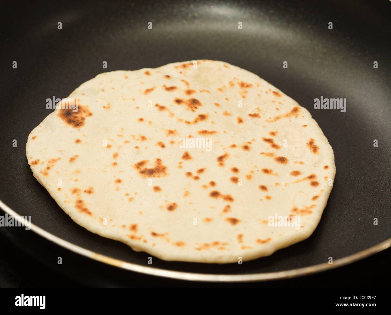 Making sourdough leavened pita-like flatbread on dry frying pan Stock ...