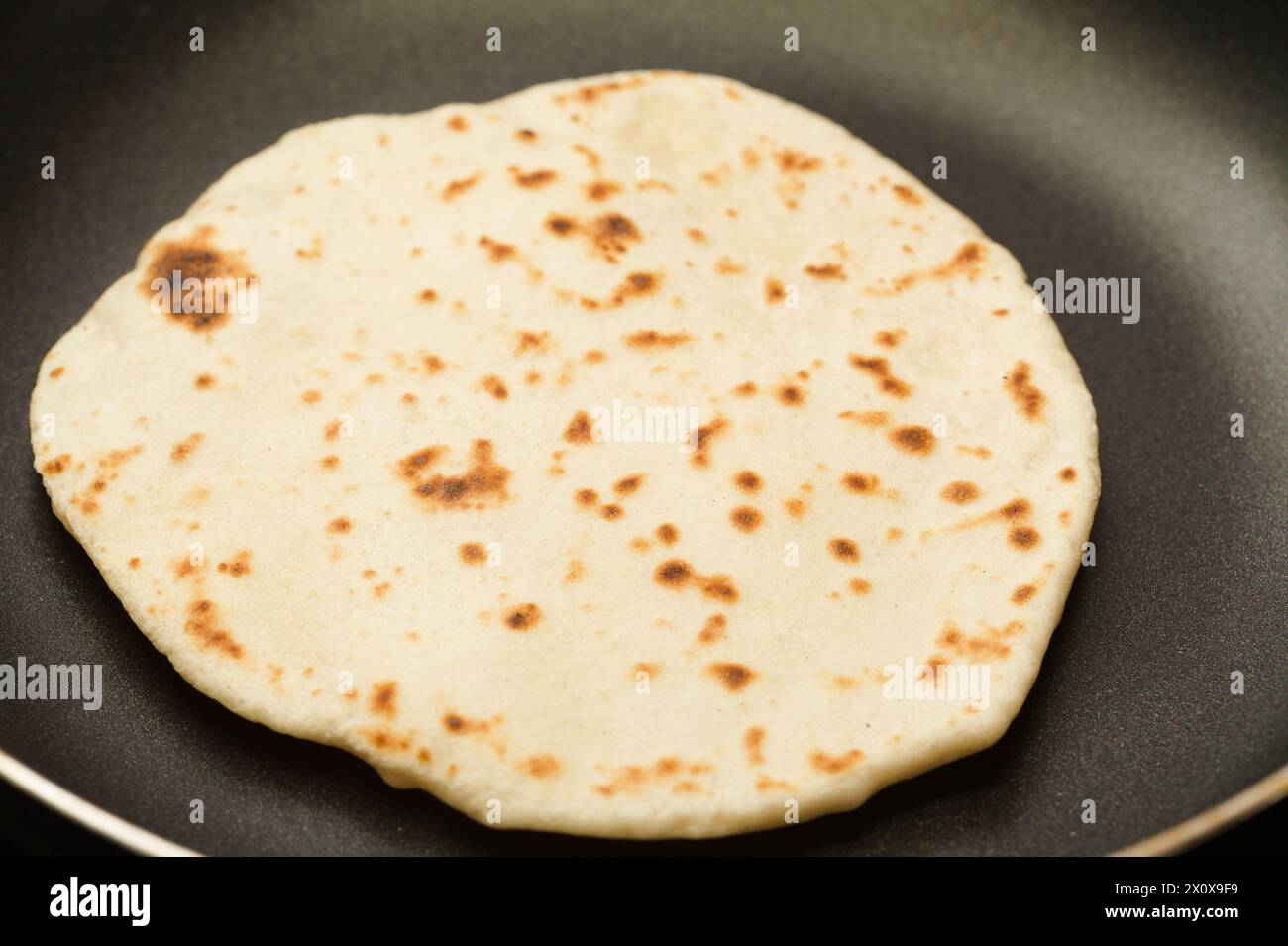 Making sourdough leavened pita-like flatbread on dry frying pan Stock ...
