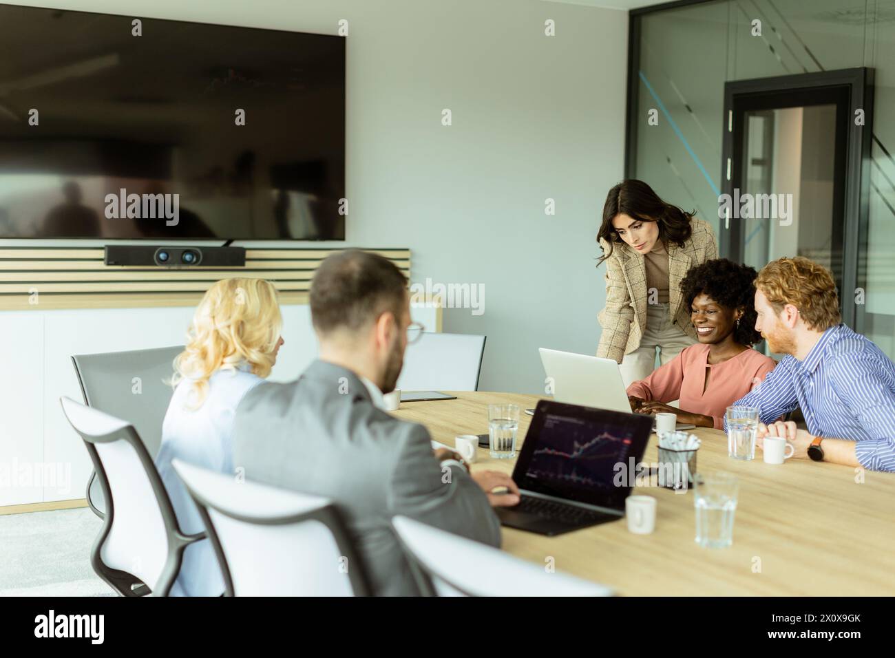 Multicultural group of professionals collaborates around a conference ...