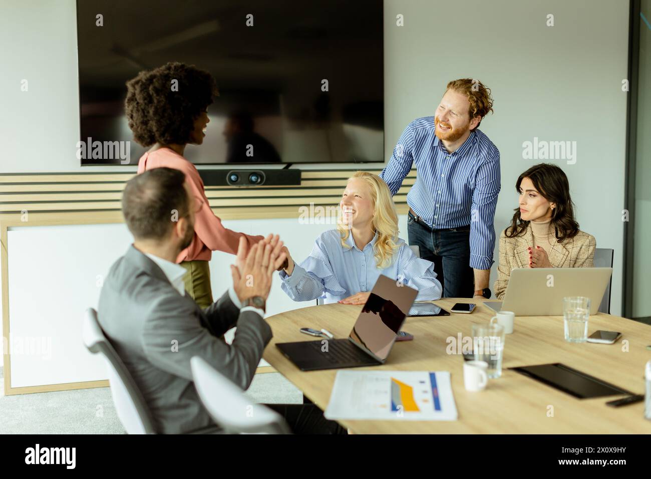 Multiethnic group of professionals brainstorming around a conference ...