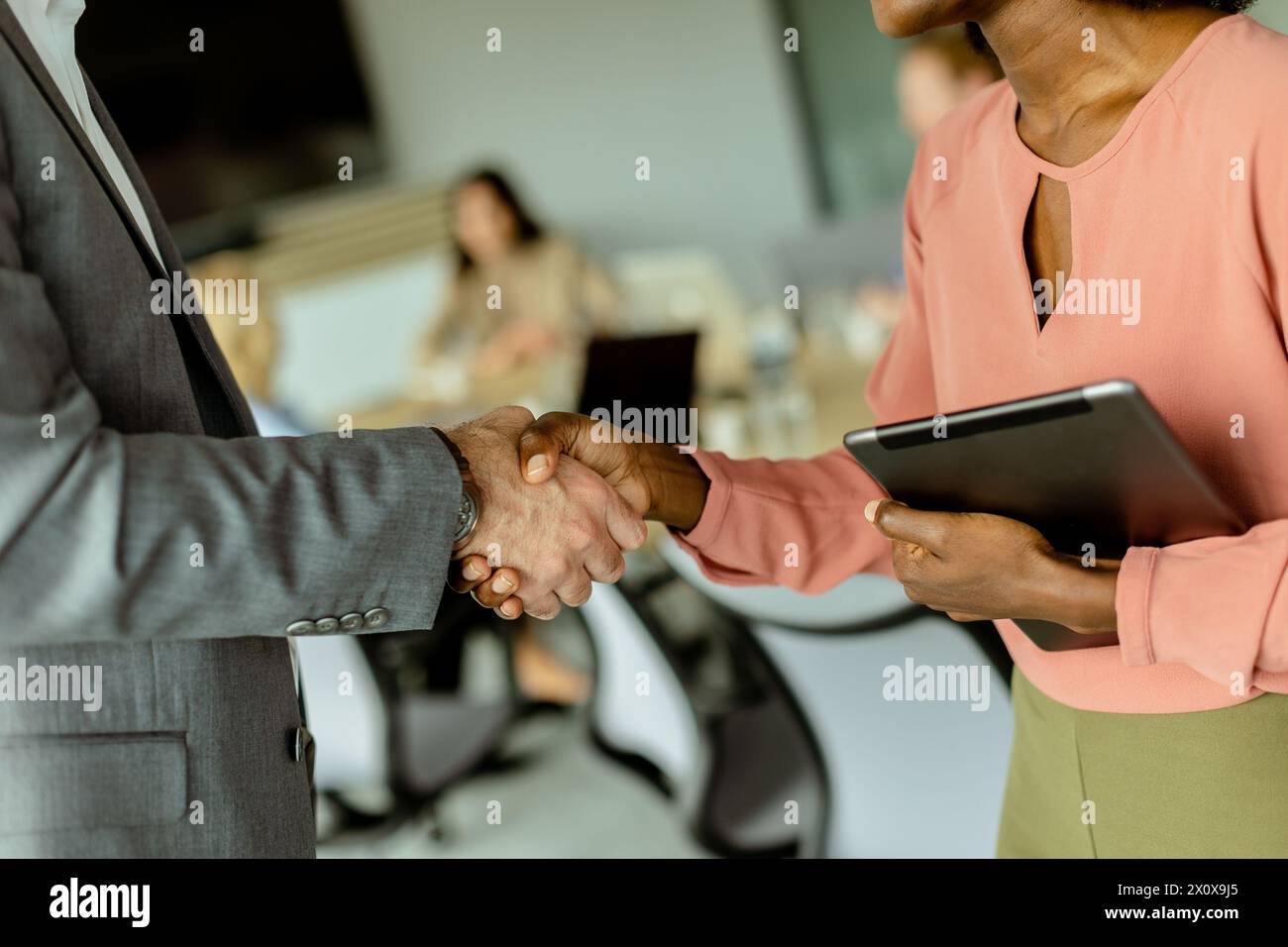Two women shaking hands warmly hi-res stock photography and images - Alamy