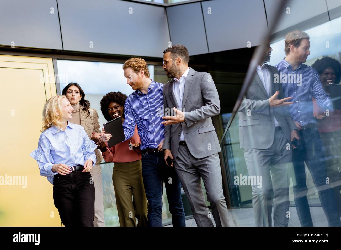 Group of colleagues in a casual business huddle, sharing ideas next to ...