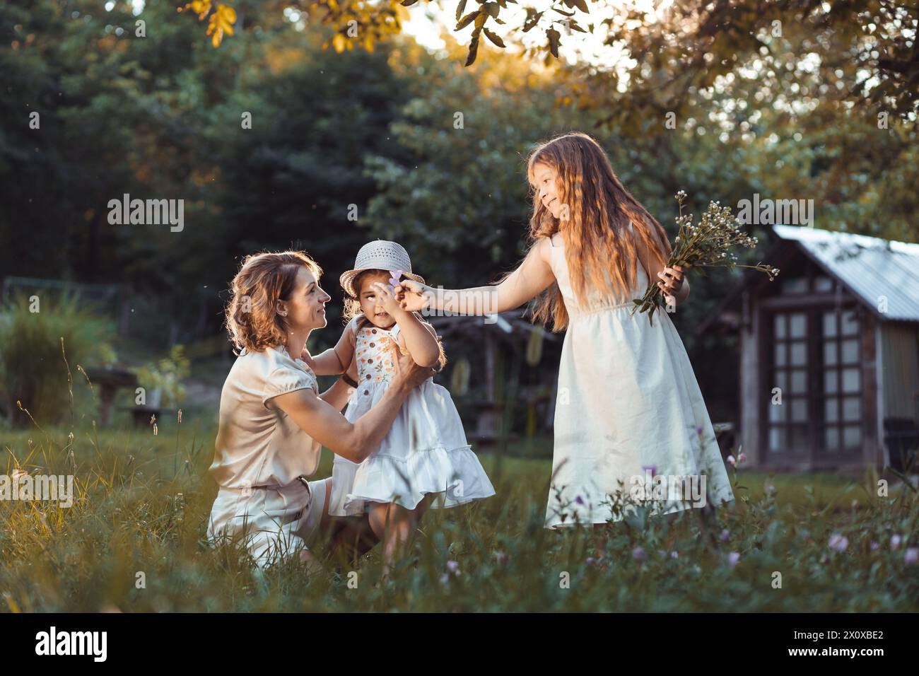 Mother and daughters enjoying a sunny weather in nature Stock Photo - Alamy