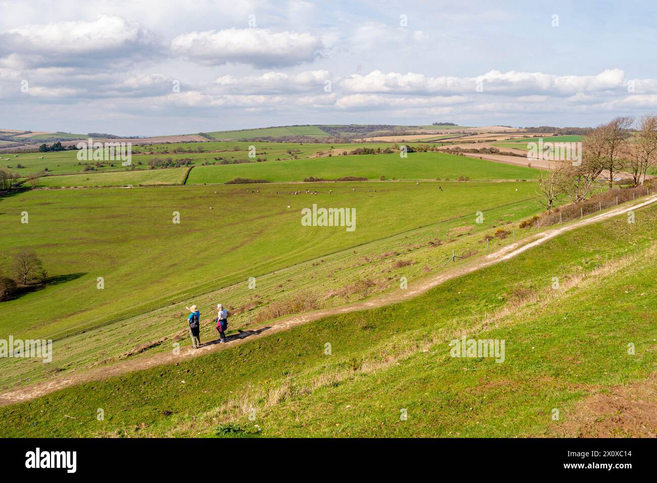 Walkers look at the view from a lower rampart of the ancient iron age ...