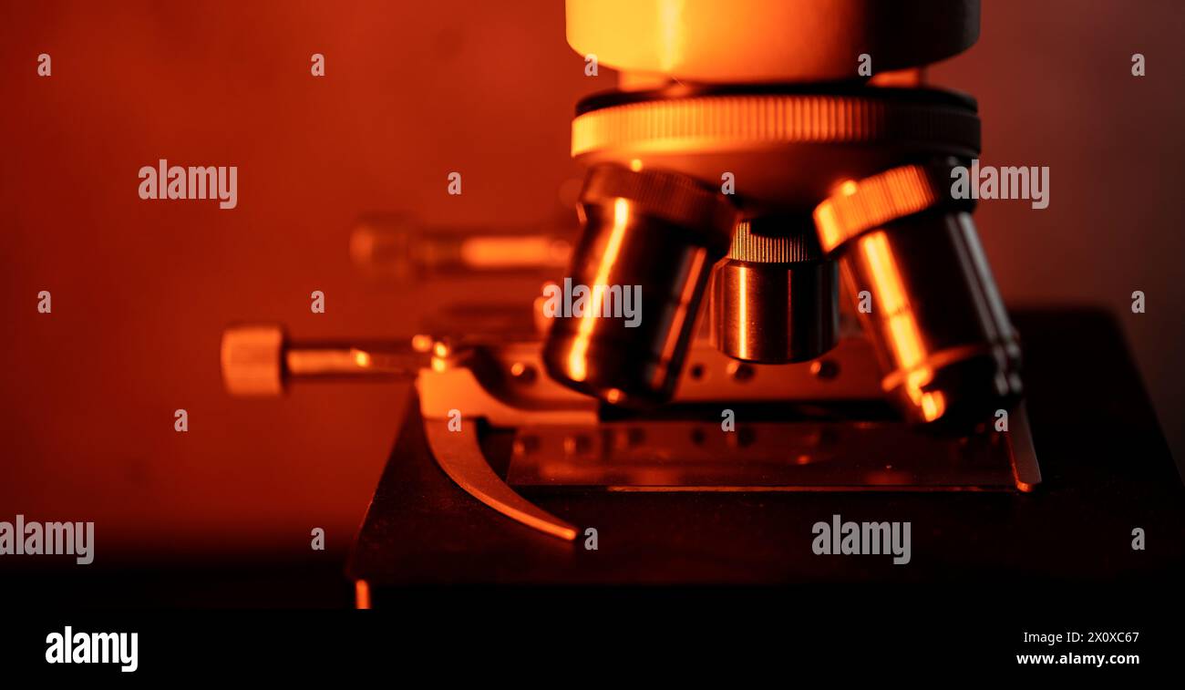 Medical microscope lenses close up, In warm red lighting Stock Photo ...