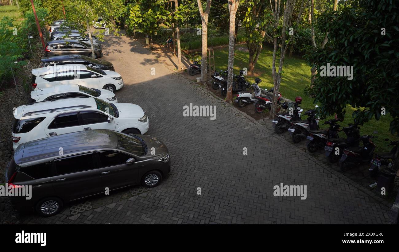 Cars and motorbikes parked neatly outside the room in a cafe and ...