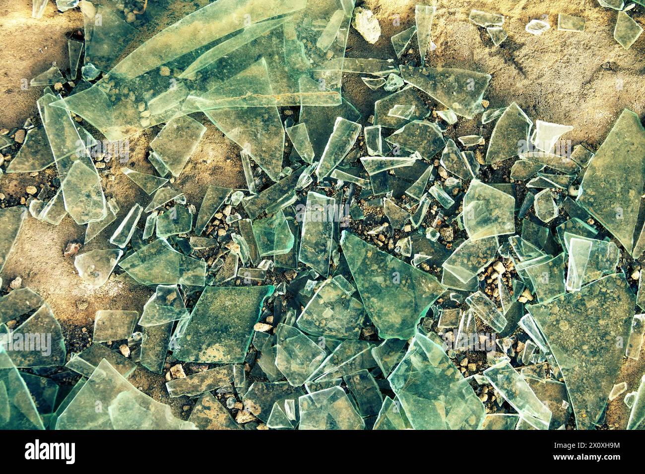 Broken glass on the concrete floor on which they walked with feet ...