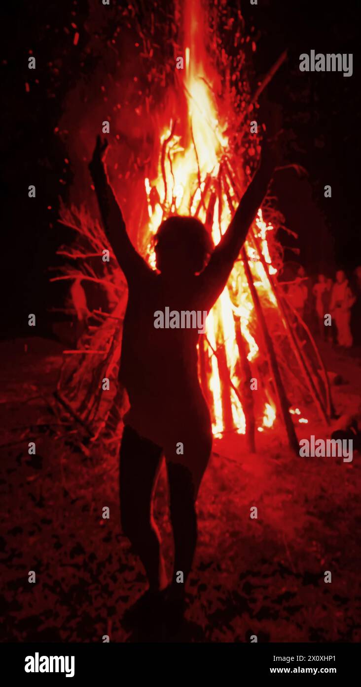 Huge fire at night and young people around. Pagan festival of Walpurgis ...