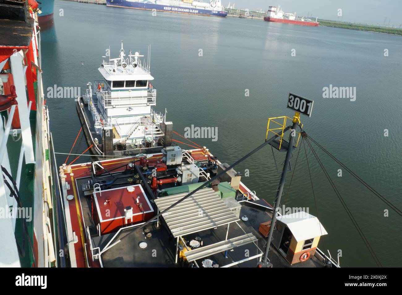Aerial view on tug boat with white superstructure and bunker barge with ...