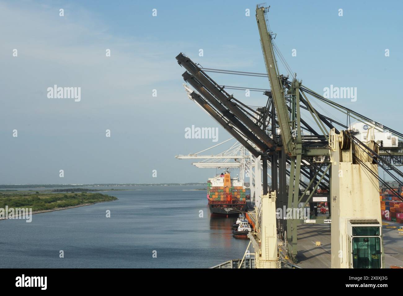 Container ship with ship cranes during cargo operation loading and ... Container ship with ship cranes during cargo operation loading and ...