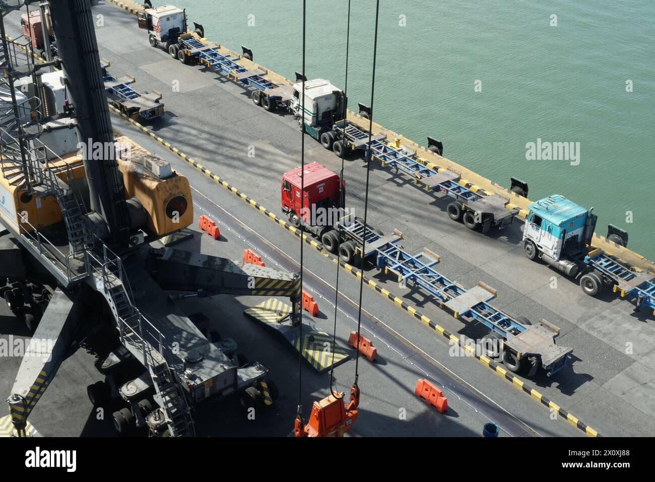 Old trucks in container terminal waiting for loading next to mobile ...