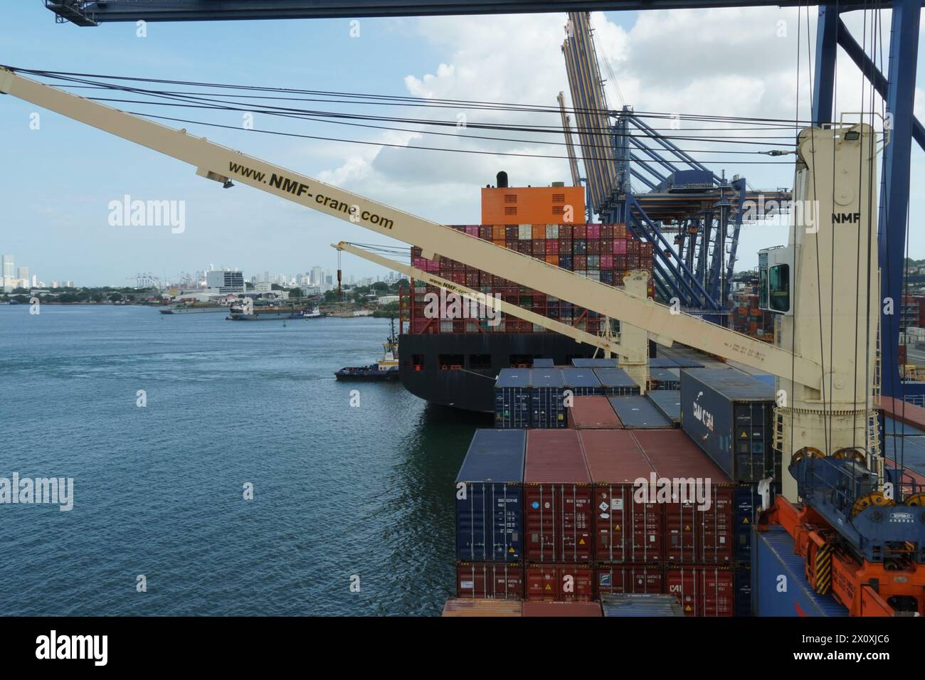 Container ship equipped with ship cranes during cargo operation loading ... Container ship equipped with ship cranes during cargo operation loading ...