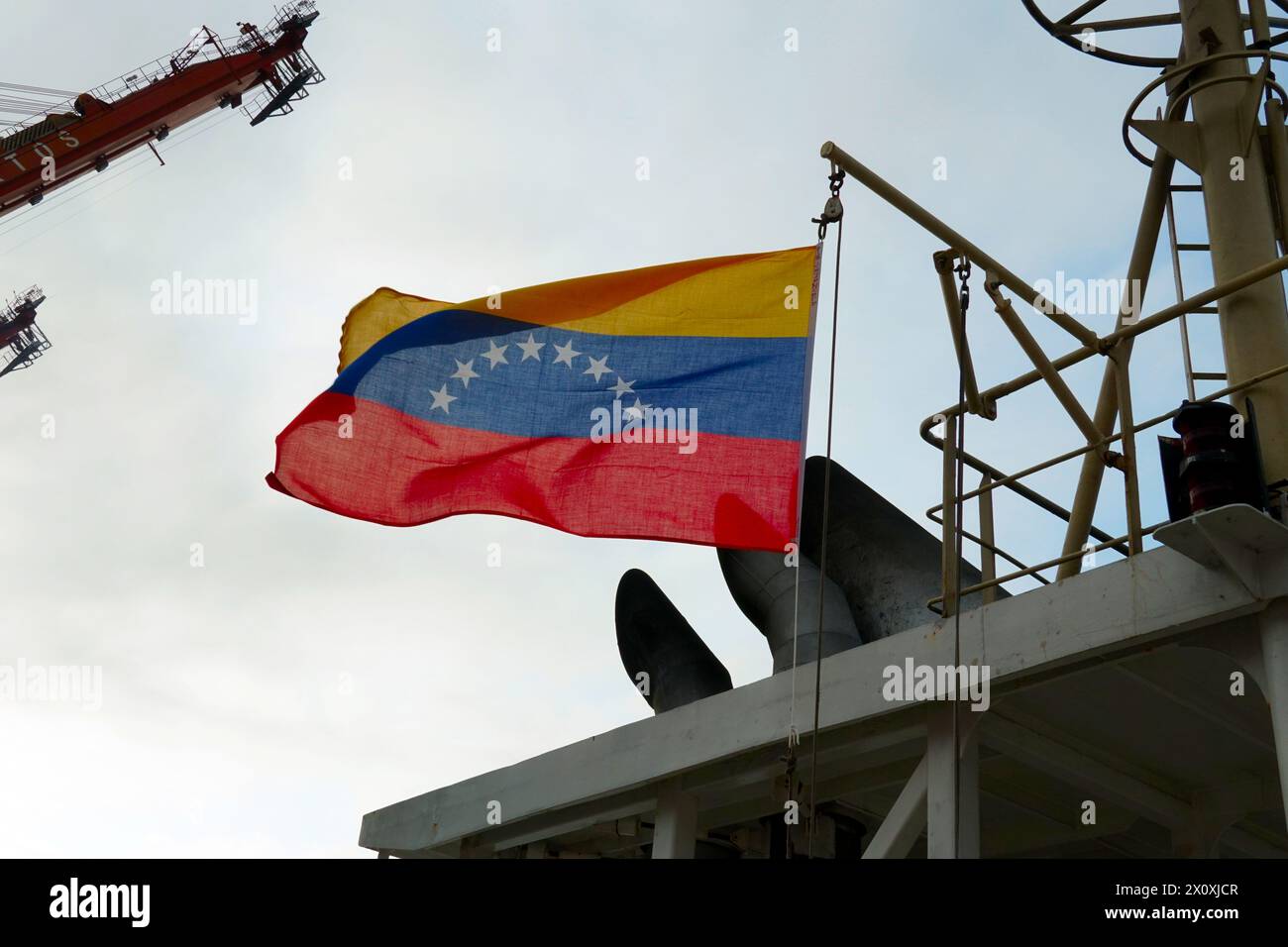 Flag of Venezuela flies on the wind and hanging on the navigational ...