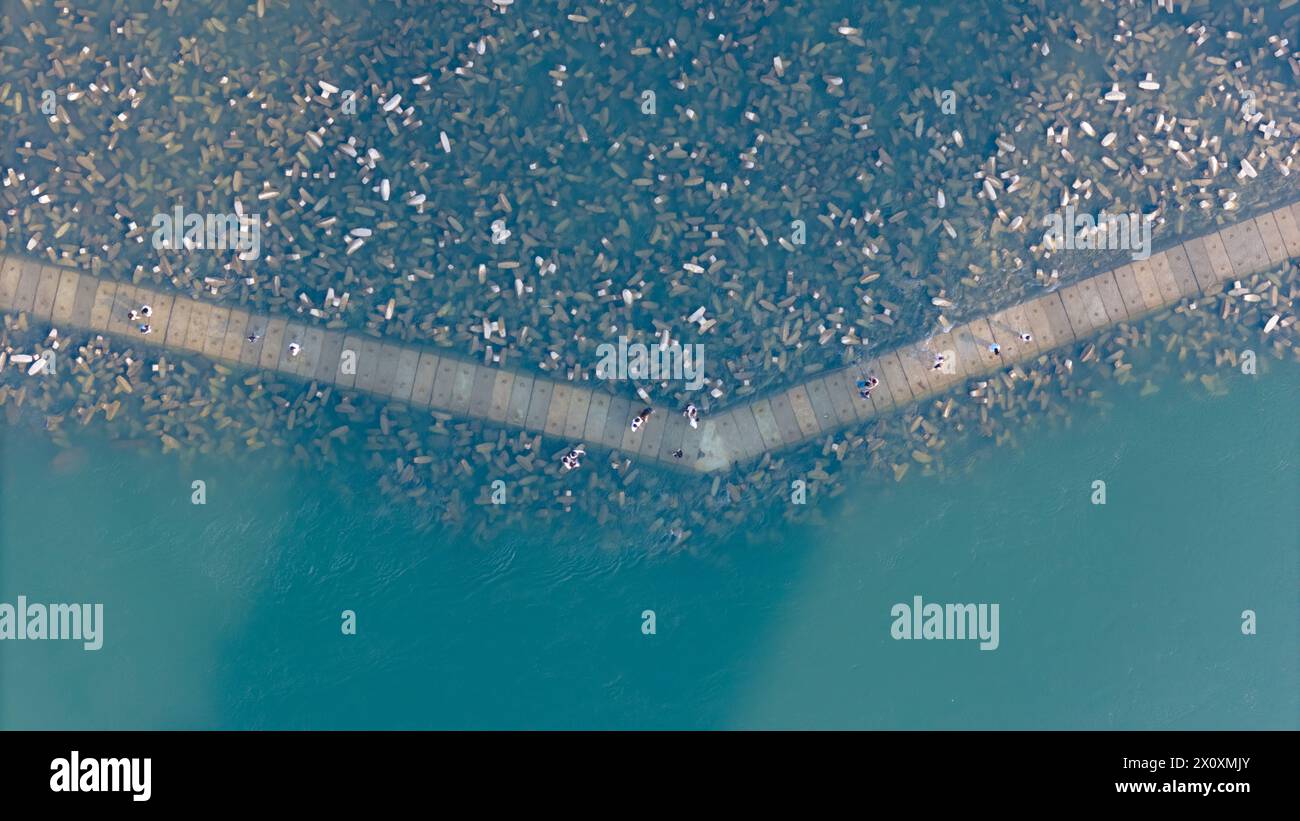 CHONGQING, CHINA - APRIL 13, 2024 - Tourists play on exposed fish nest ...