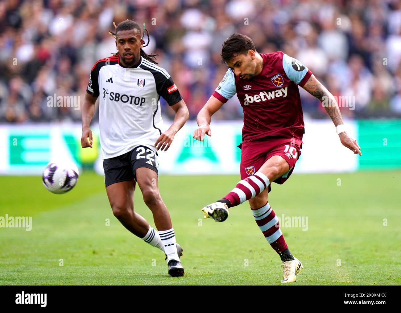 West Ham United's Lucas Paqueta (right) shoots the ball past Fulham's ...
