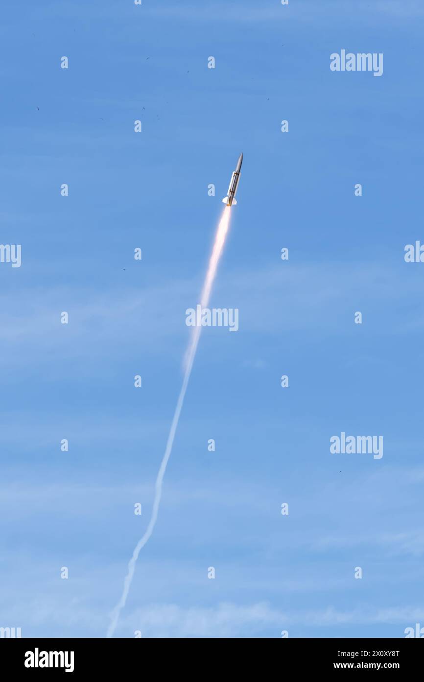Ballistic missile in the sky above clouds, trace of missile launch, 3d ...