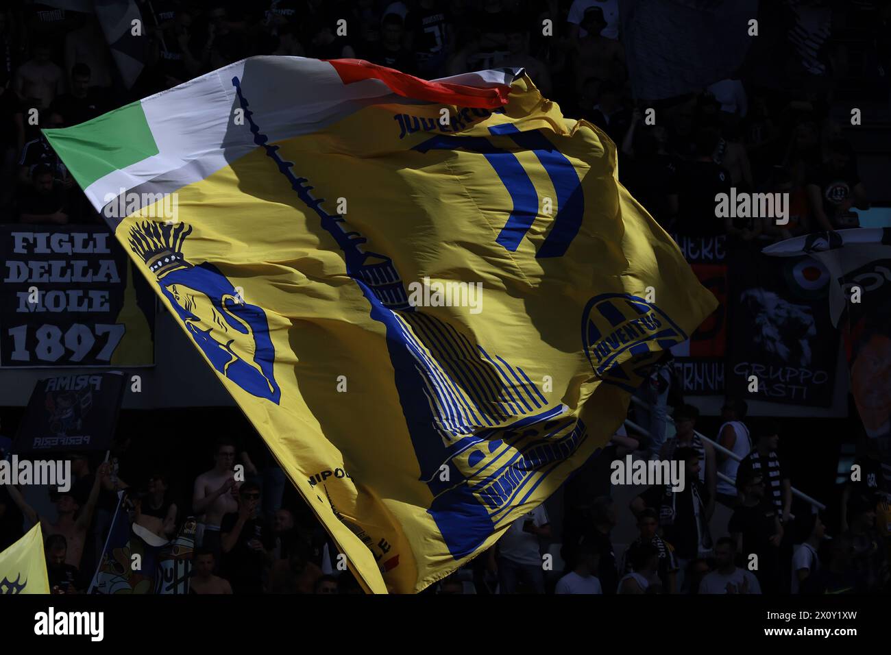 Turin, Italy. 13th Apr, 2024. Juventus fans wave a giant flag bearing ...