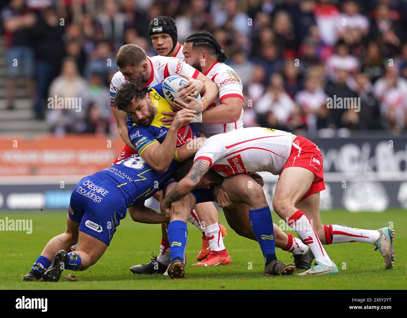 Warrington Wolves' Toby King tackled by St Helens' Joe Batchelor ...