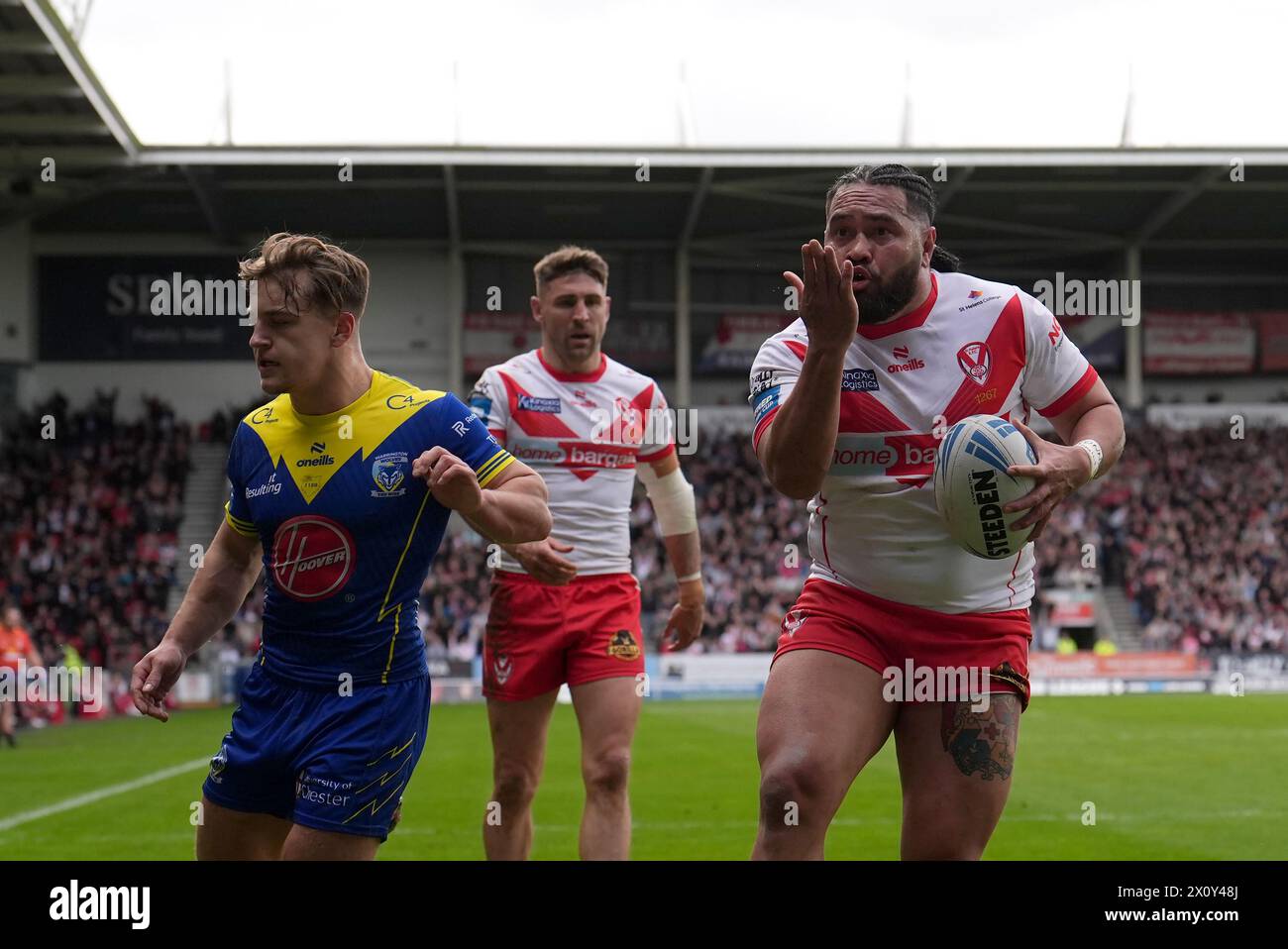 St Helens' Konrad Hurrell (right) celebrates scoring their side's first ...