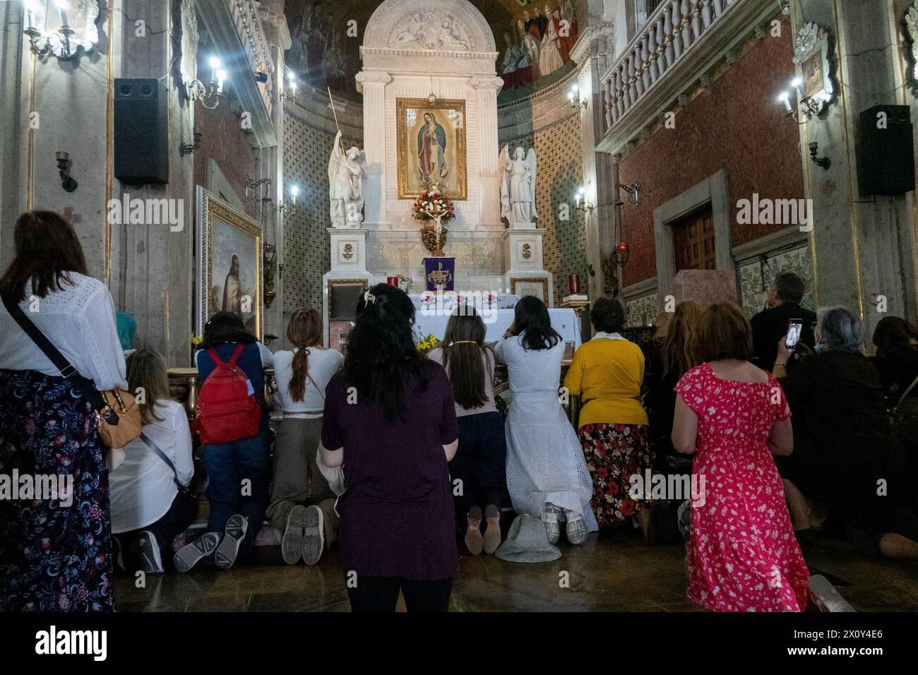 Mexico City, Mexico. 12th Mar, 2024. Tourists and locals pray at The ...
