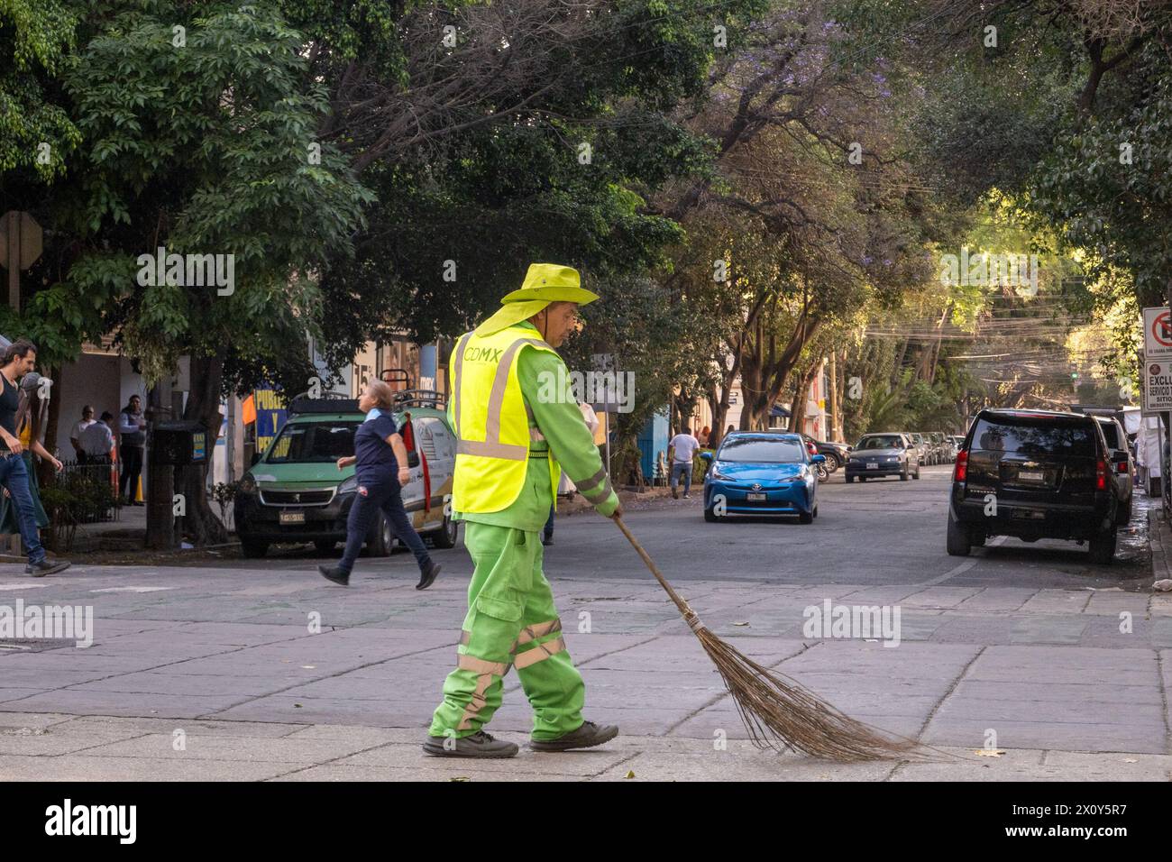 City worker sweeps the street in Mexico City. The city street sweepers ...