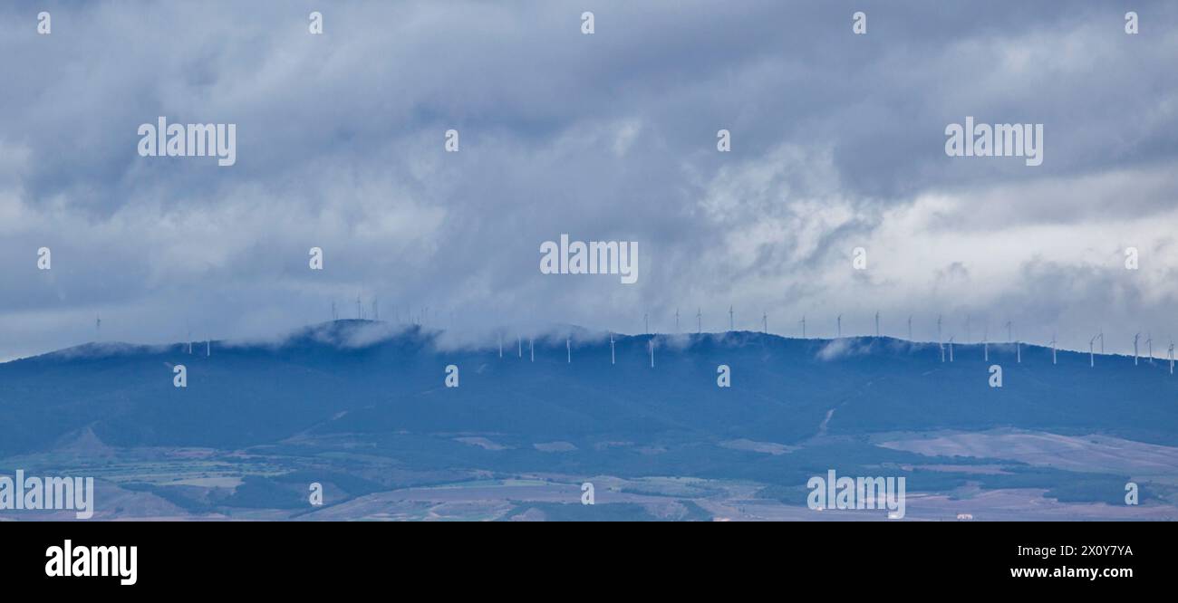 Wind park on the top of the hills. Clouds partially hide the wind ...