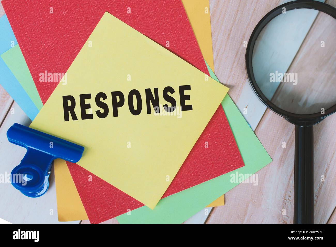 Response word on colorful adhesive paper with magnifying glass Stock ...