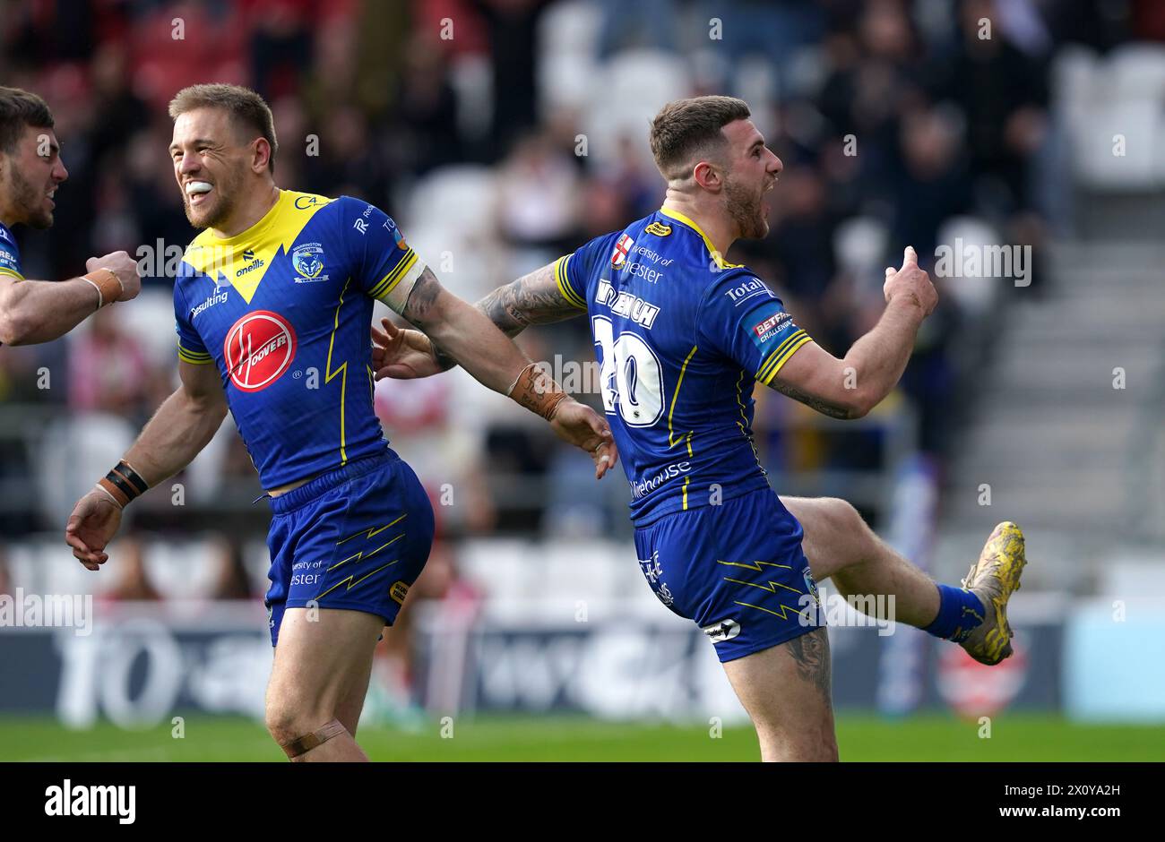 Warrington Wolves' Connor Wrench (right) celebrates scoring their side ...