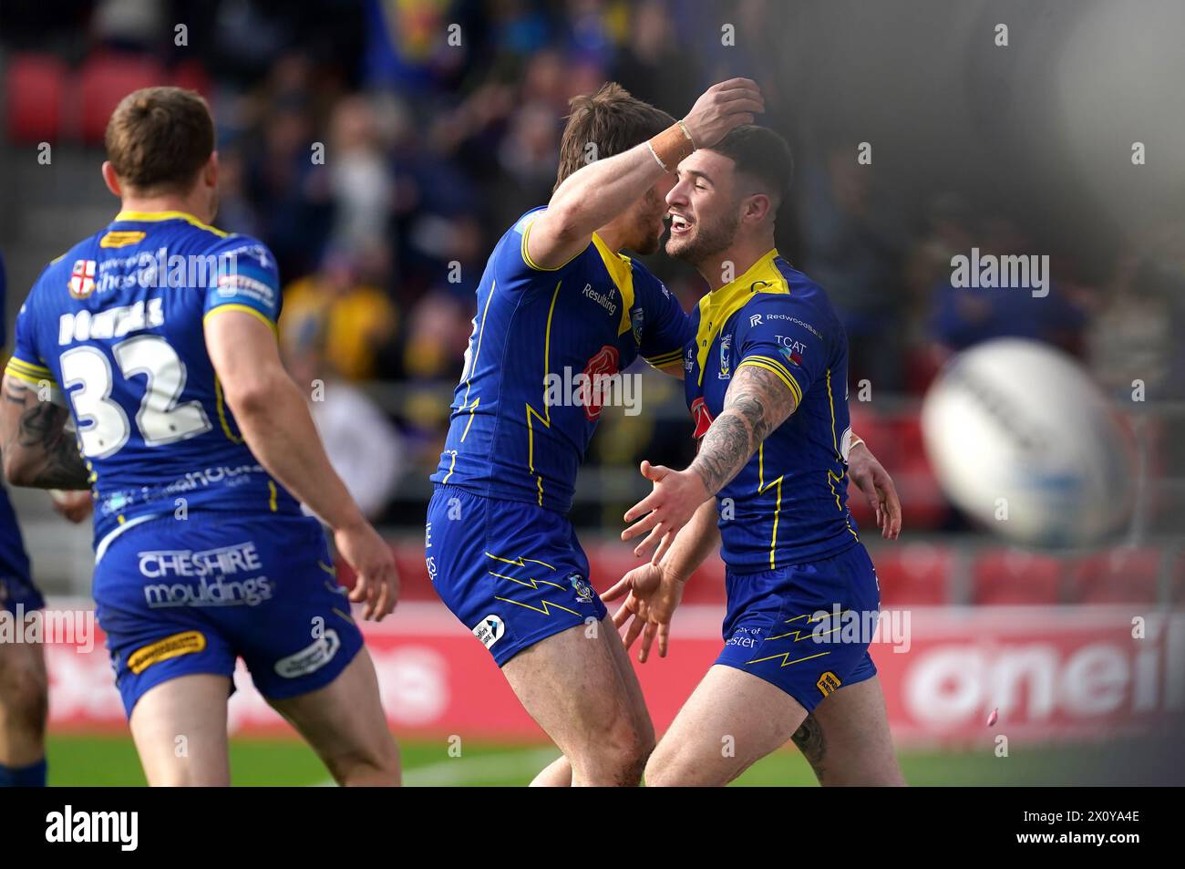 Warrington Wolves' Connor Wrench (right) celebrates scoring their side ...