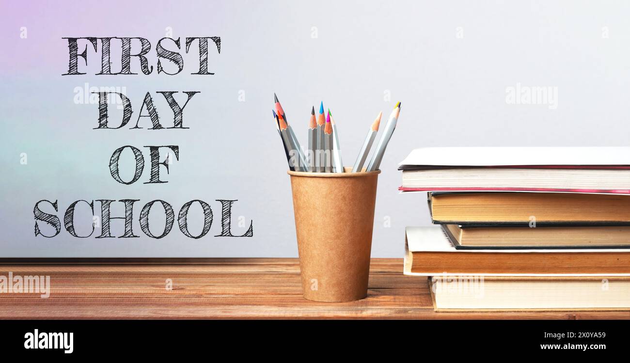 A wooden desk with a cup of pencils and a stack of books. The words ...
