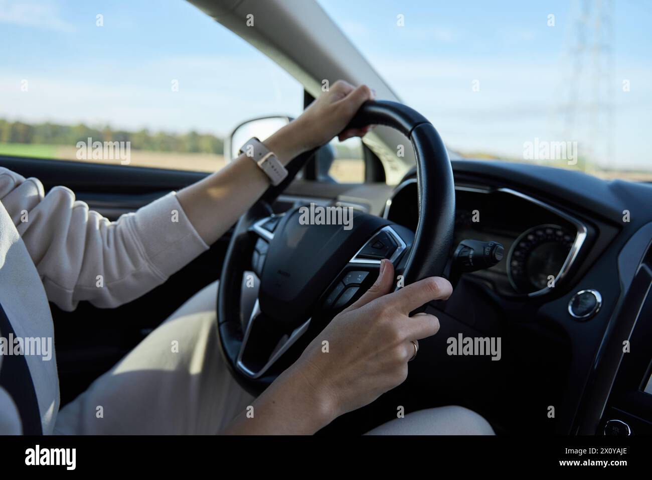 Inside view of woman driving car on countryside road. Female drivers ...