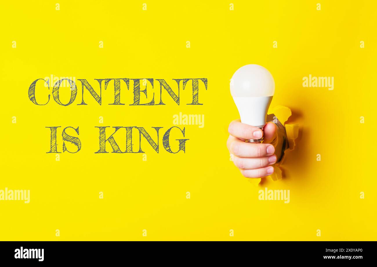 A person holding a light bulb with the words content is king written ...