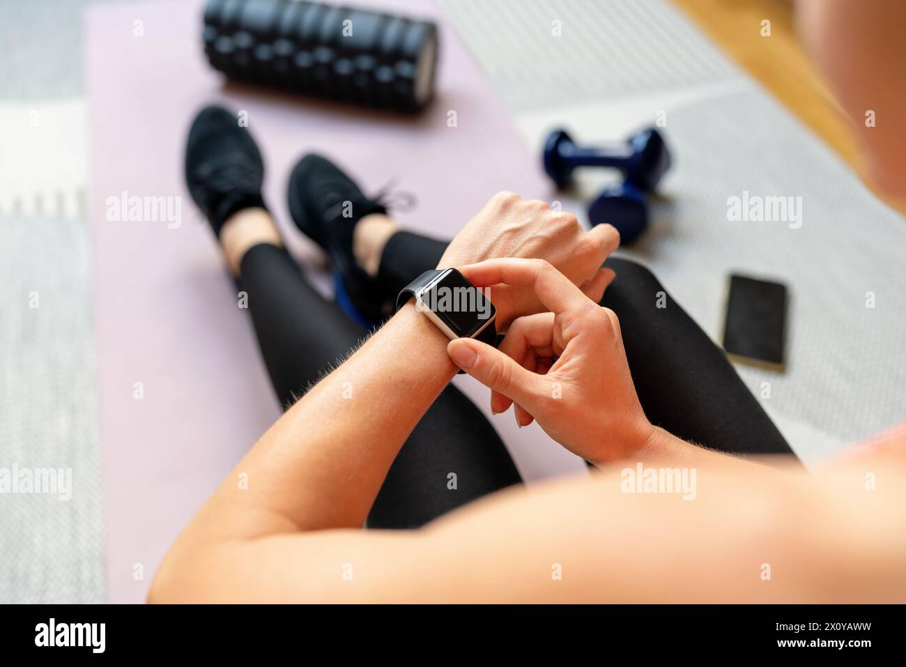 Sporty woman setting workout program using her smartwatch. Fitness ...