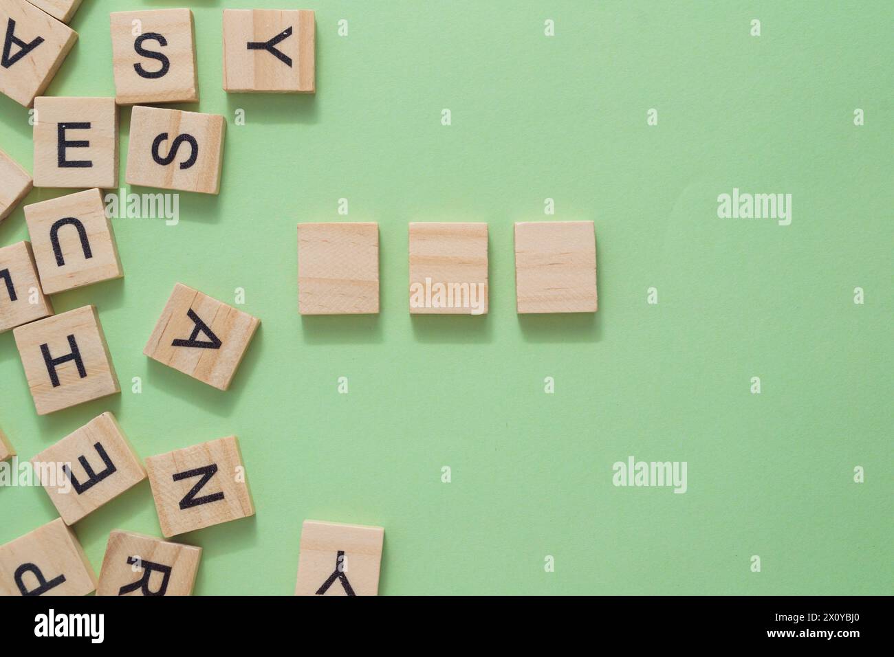 Three wooden blocks are on a green background with the letters Stock ...