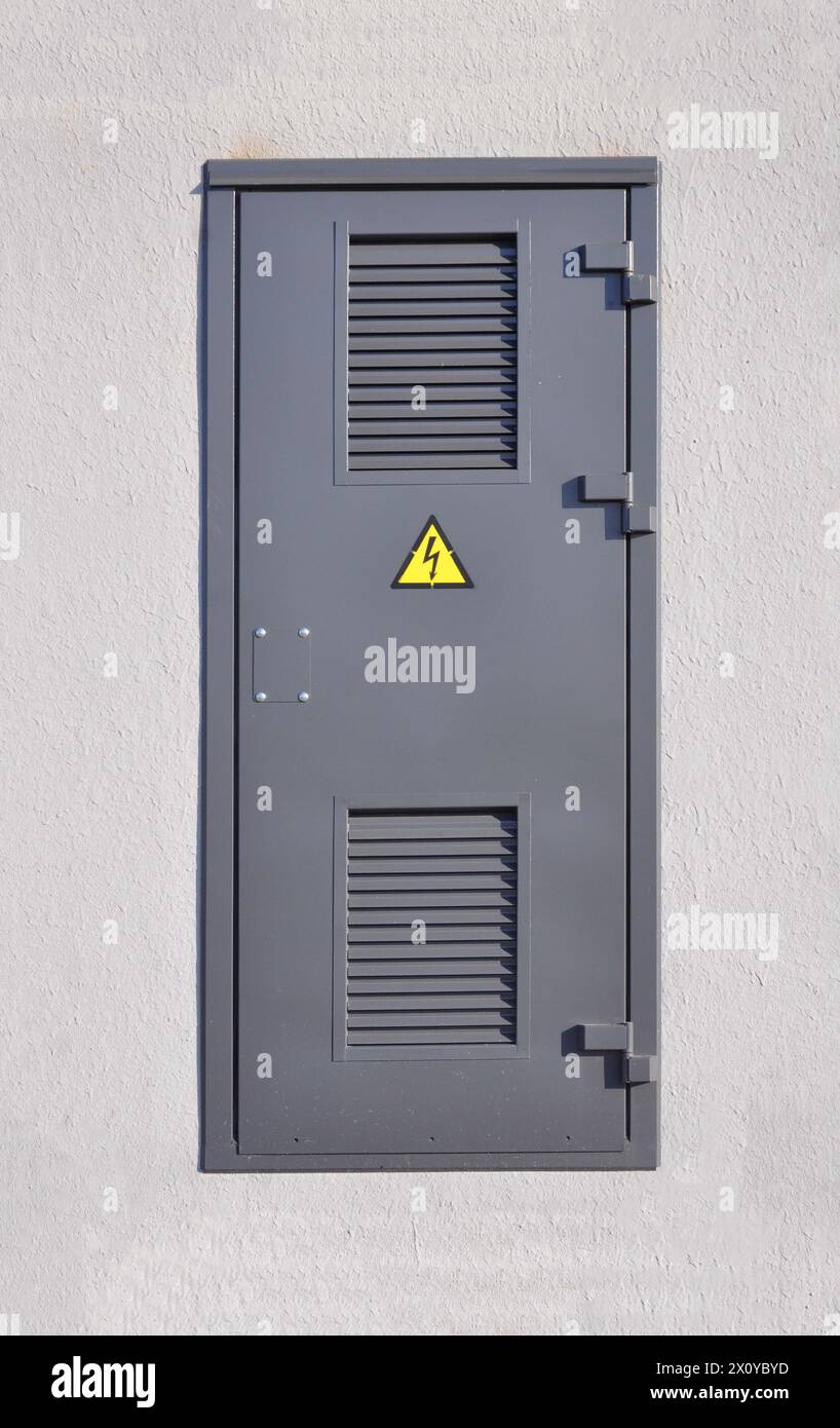Gray metal door against a white wall. Electrical hazard. Transformer ...