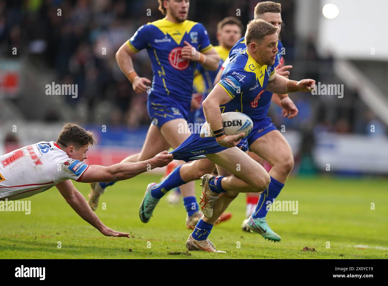 Warrington Wolves' Matthew Dufty evades St Helens' Jack Welsby during ...