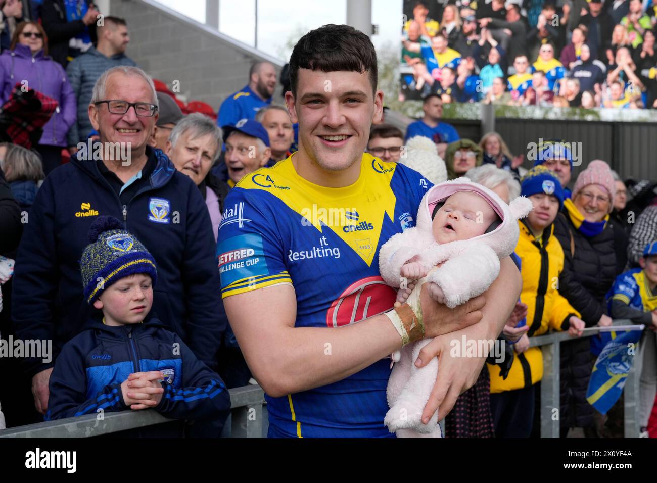 Josh Thewlis of Warrington Wolves celebrates with his young baby after ...