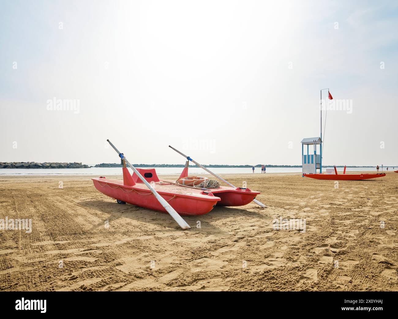 Lifeboat and lifeguard tower on the beach, on a sunny summer morning ...
