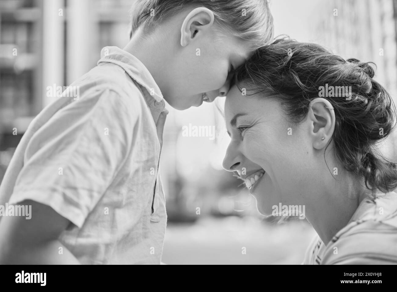 Adorable mother and son smiling happy having fun at city background ...