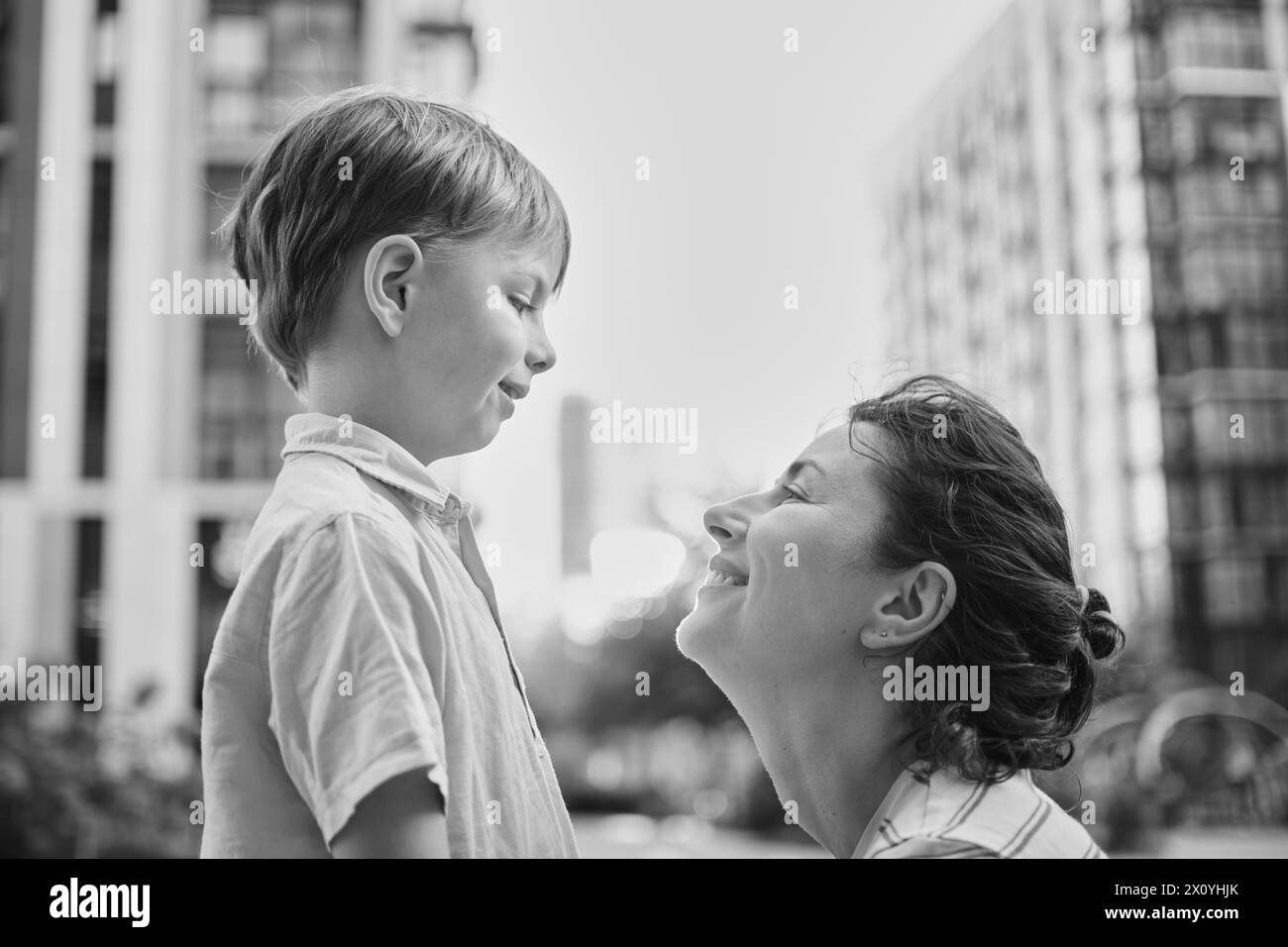 Adorable mother and son smiling happy having fun at city background ...