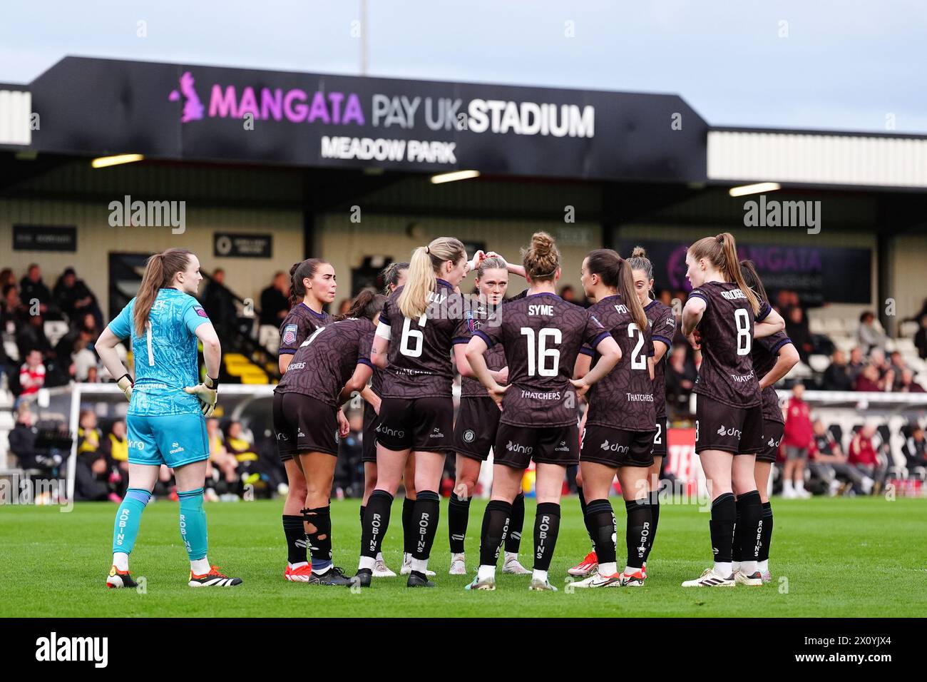 Bristol City players form a huddle after Arsenal's third goal during ...