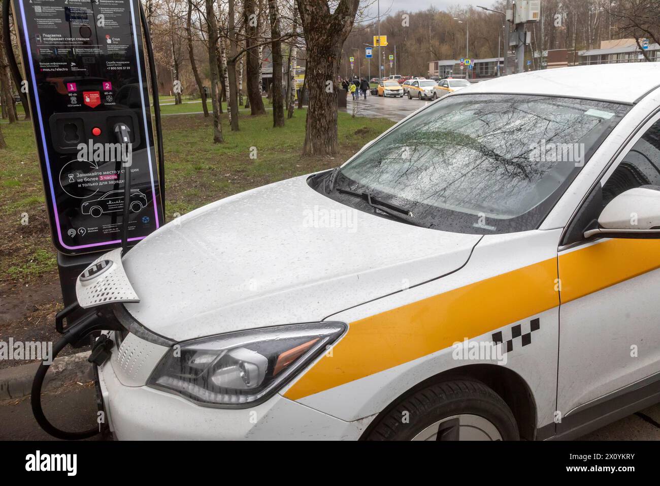 Moscow, Russia. 14th of April, 2024. An electric taxi car is charging ...