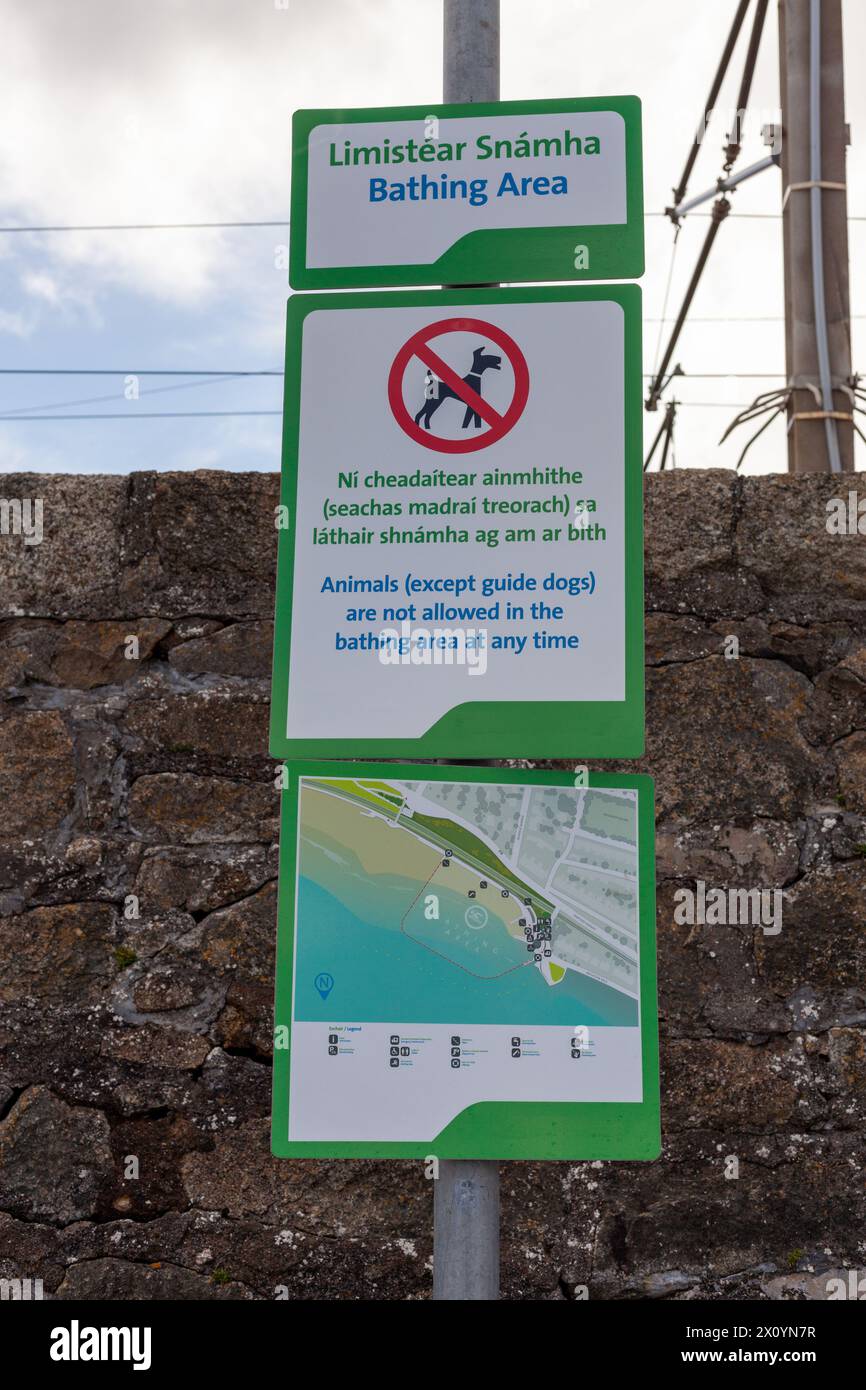 Road sign indicating a bathing area with a map and sign forbidding pets ...