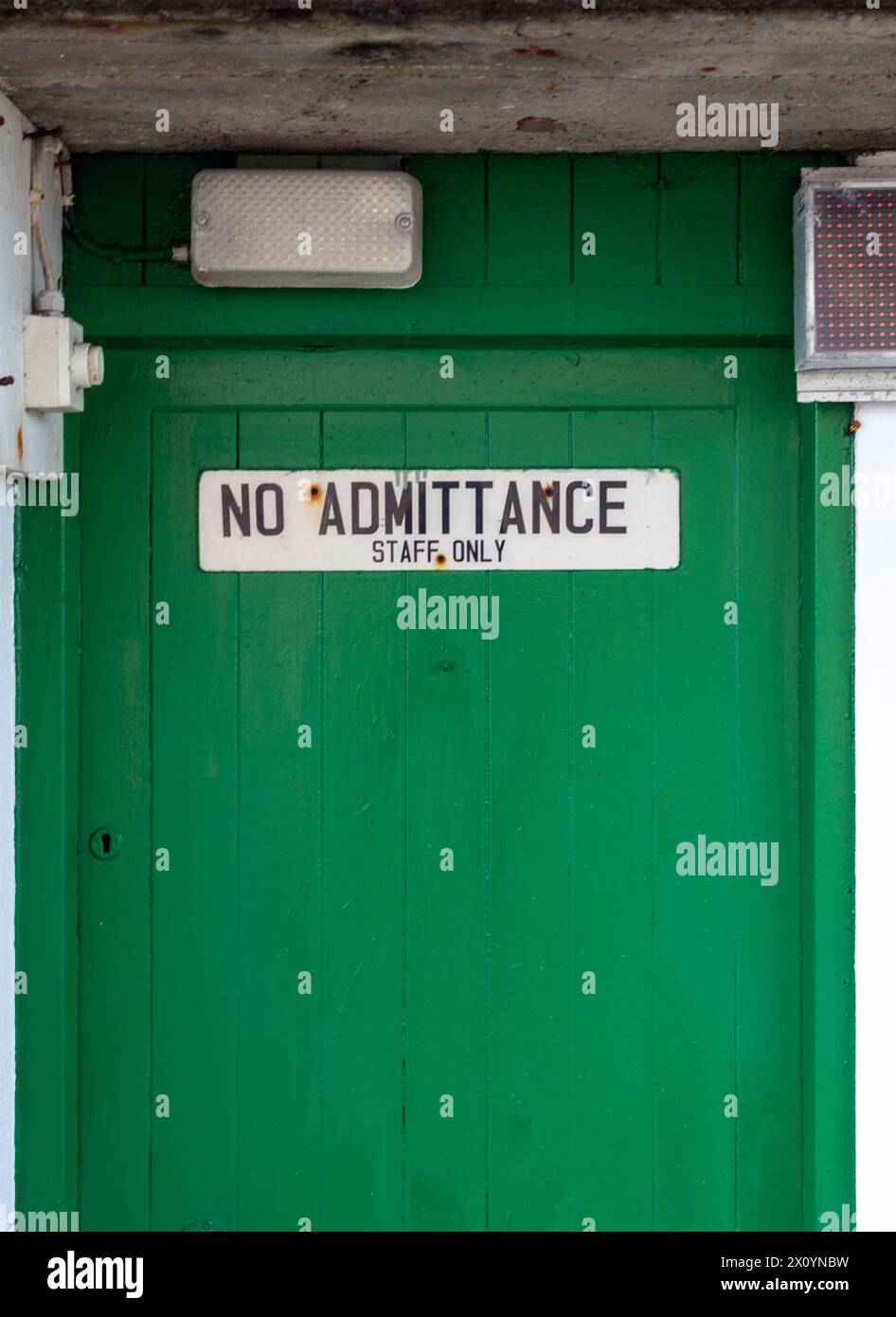 No admittance staff only sign with lamps and electrical wires on a ...
