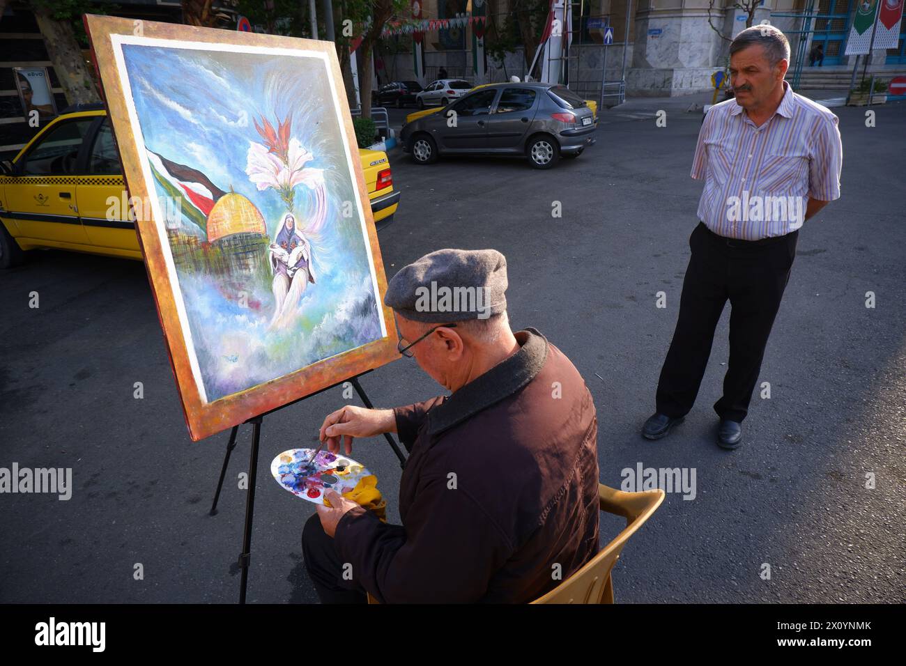 Tehran, Iran. 14th Apr, 2024. An Iranian man painting a picture of the ...