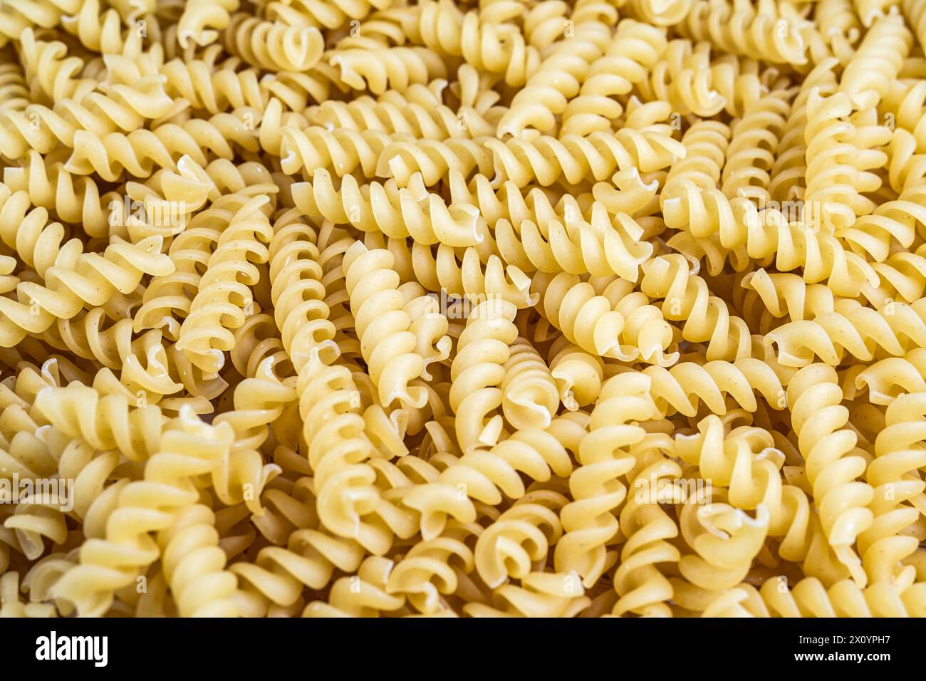 A pile of raw italian fusilli spiral pasta. Texture background Stock ...