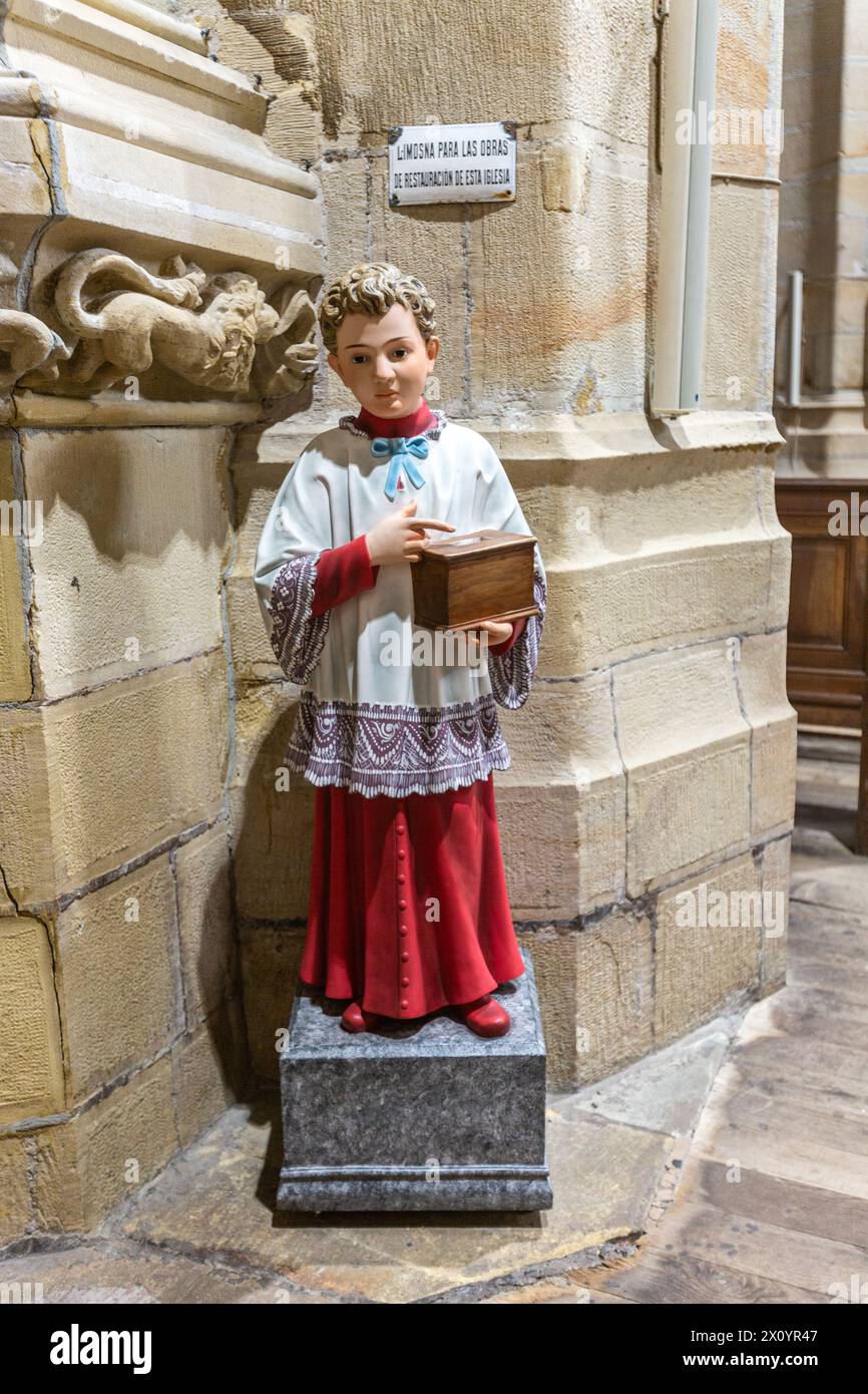 Statue of an altar boy asking alms hi-res stock photography and images ...