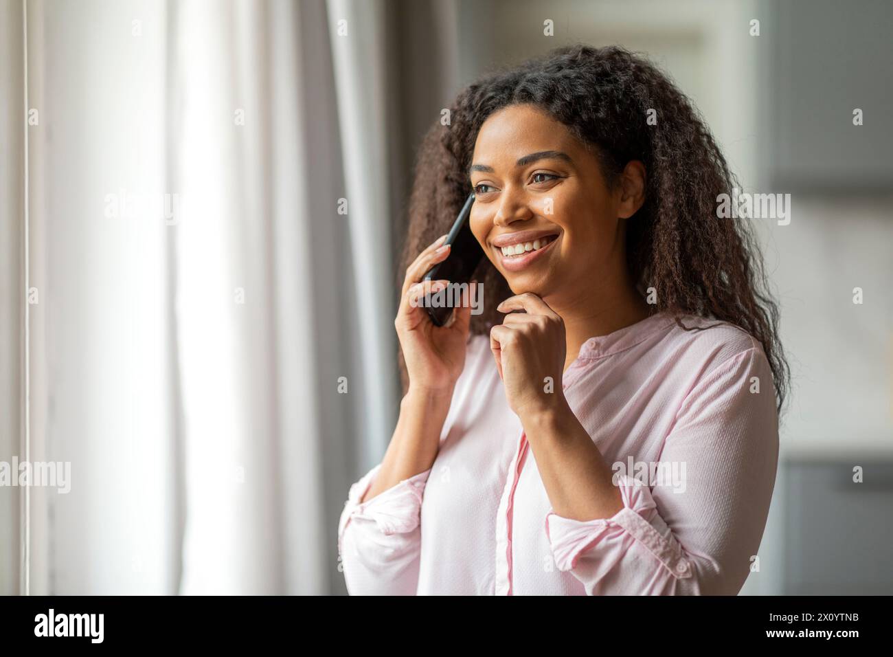 African american lady taking a phone call Stock Photo - Alamy